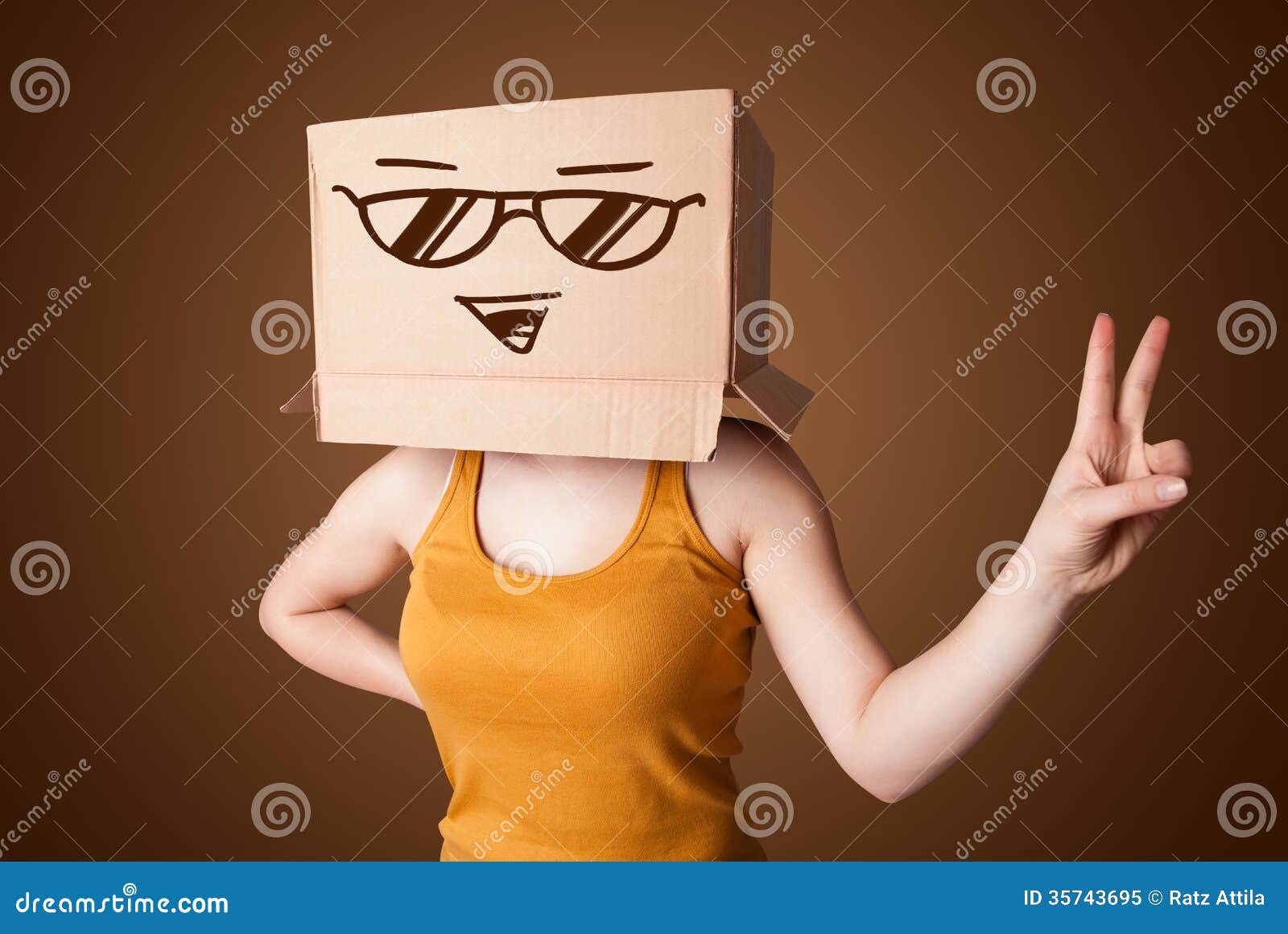 Young Lady Gesturing with a Cardboard Box on Her Head with Smile Stock ...