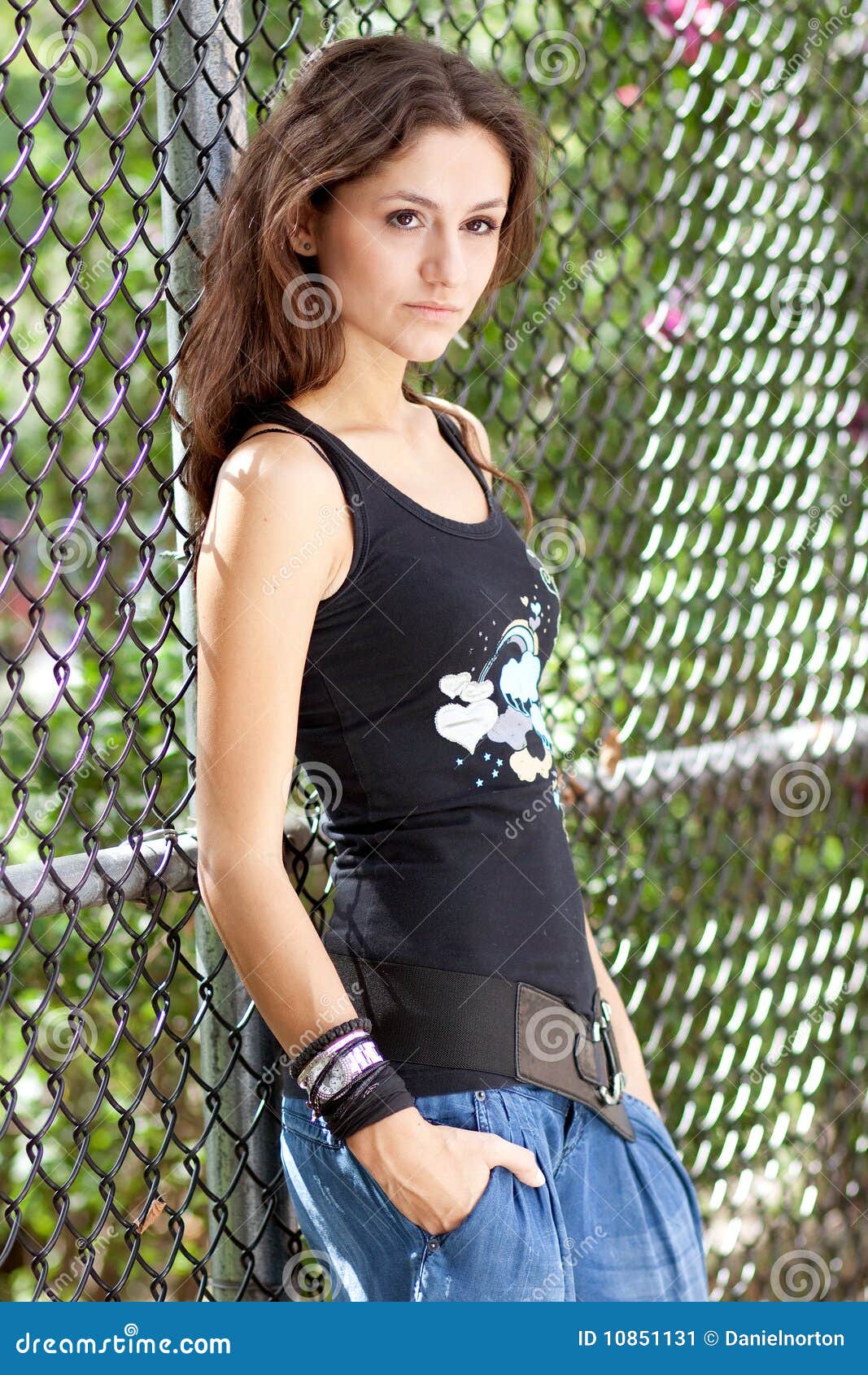 Young Lady Leaning Against Fence Stock Image - Image of model, belt ...