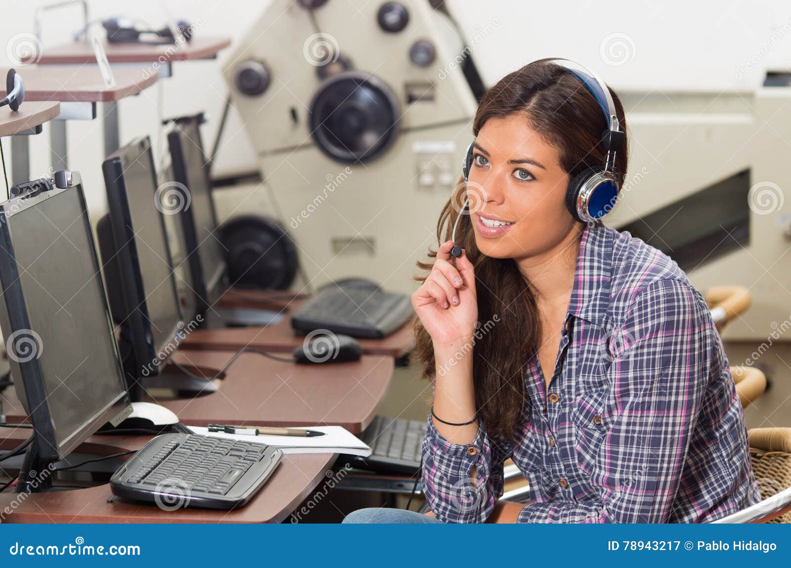 Young Lady Sitting in Front of the Computer and Using Headseat Stock ...