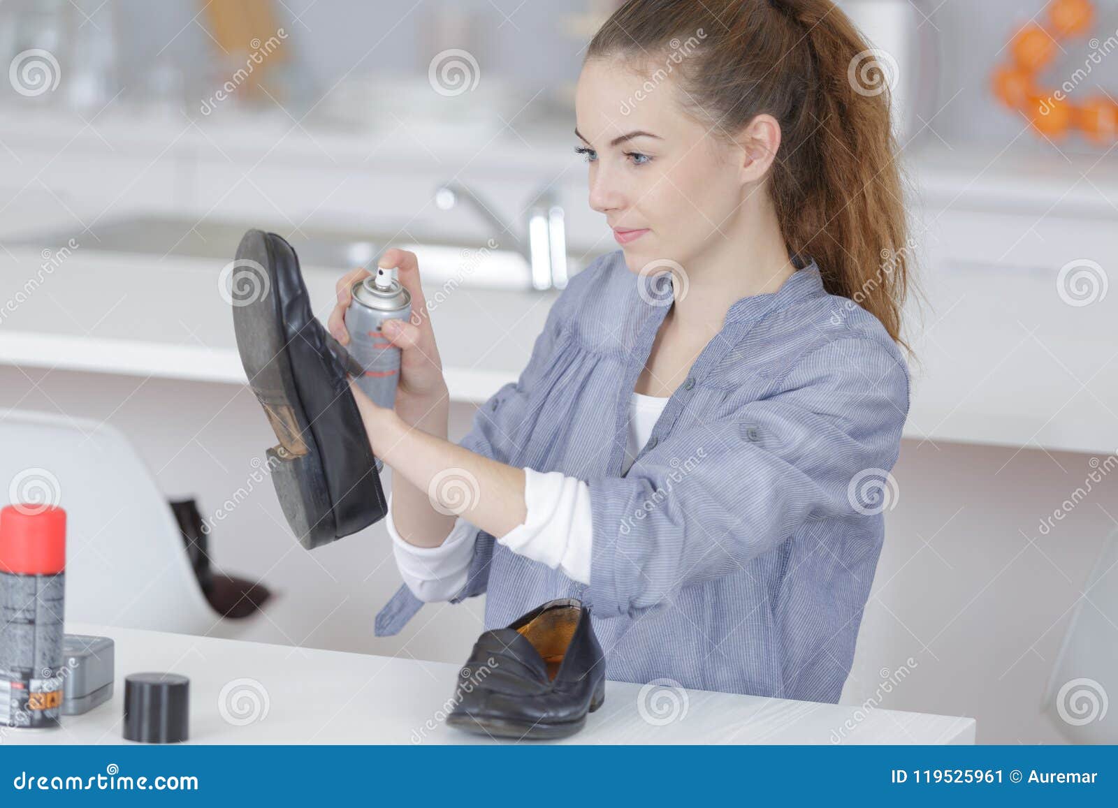 Young lady spraying shoe stock image. Image of spraying - 119525961