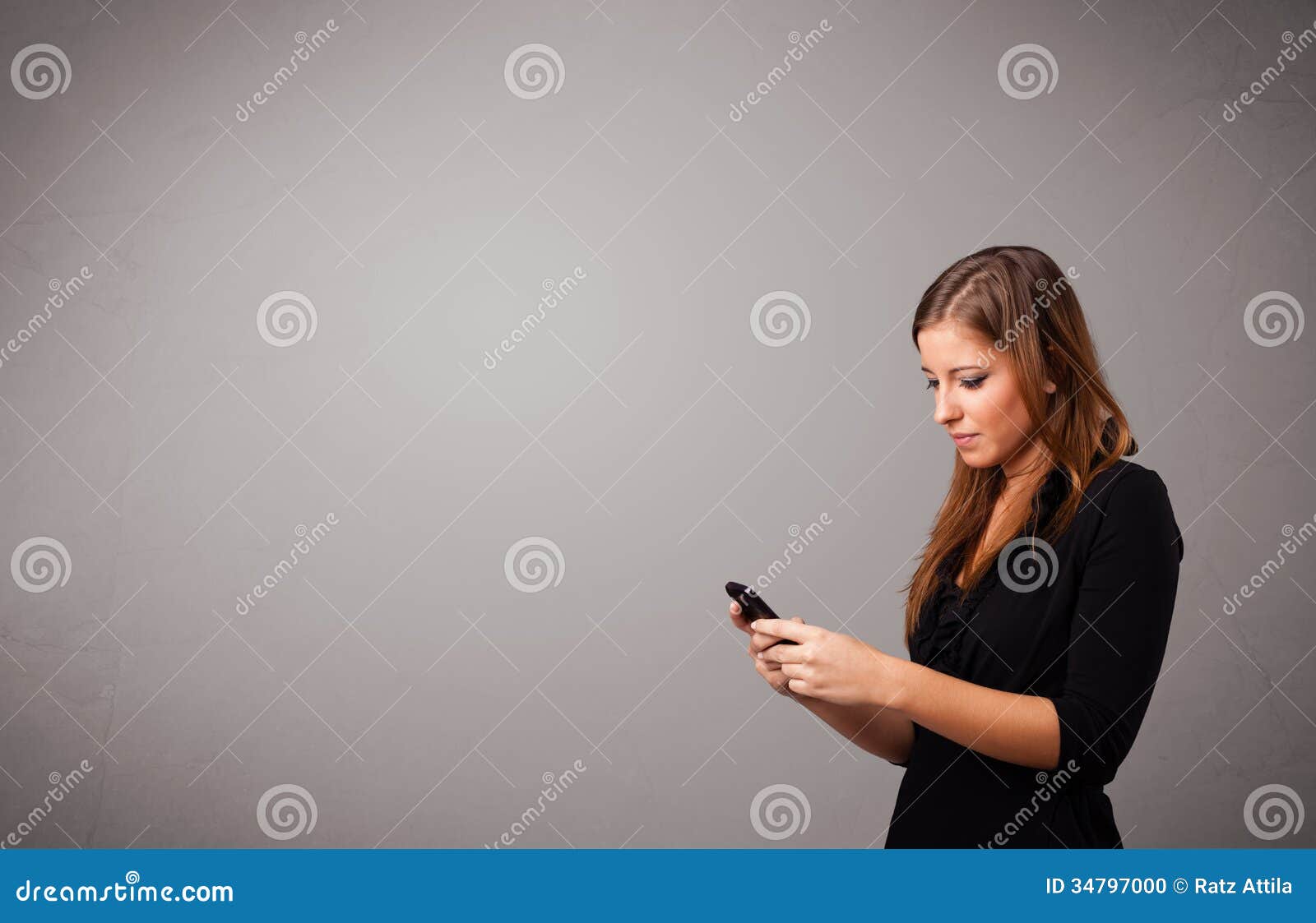 Young Lady Standing and Holding a Phone with Copy Space Stock Photo ...