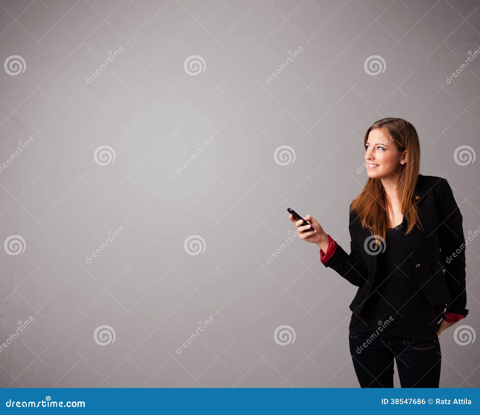Young Lady Standing and Holding a Phone with Copy Space Stock Photo ...