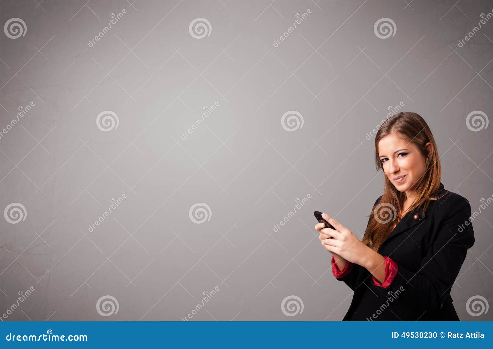 Young Lady Standing and Holding a Phone with Copy Space Stock Photo ...