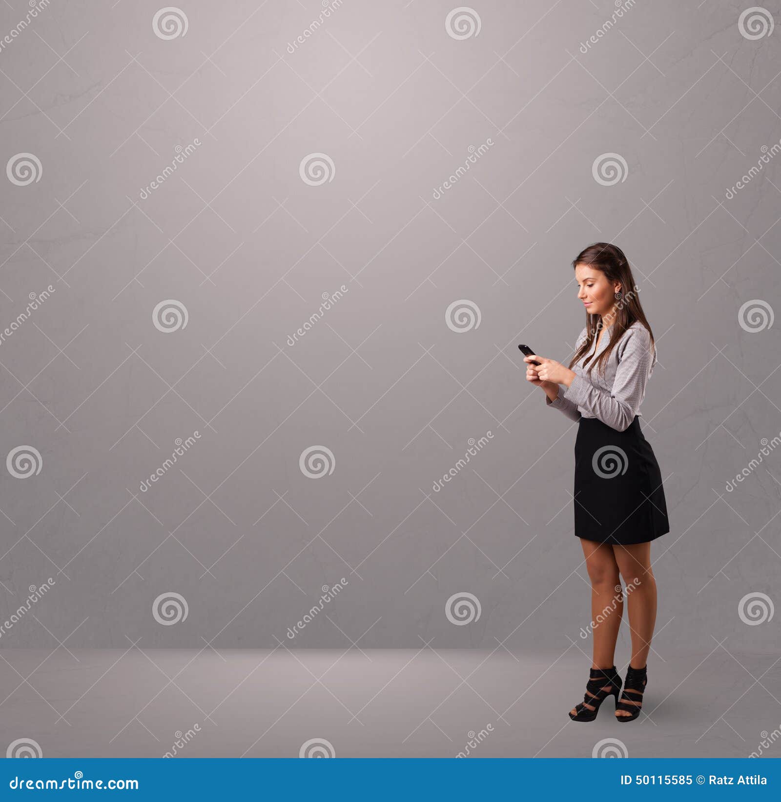 Young Lady Standing and Holding a Phone with Copy Space Stock Image ...