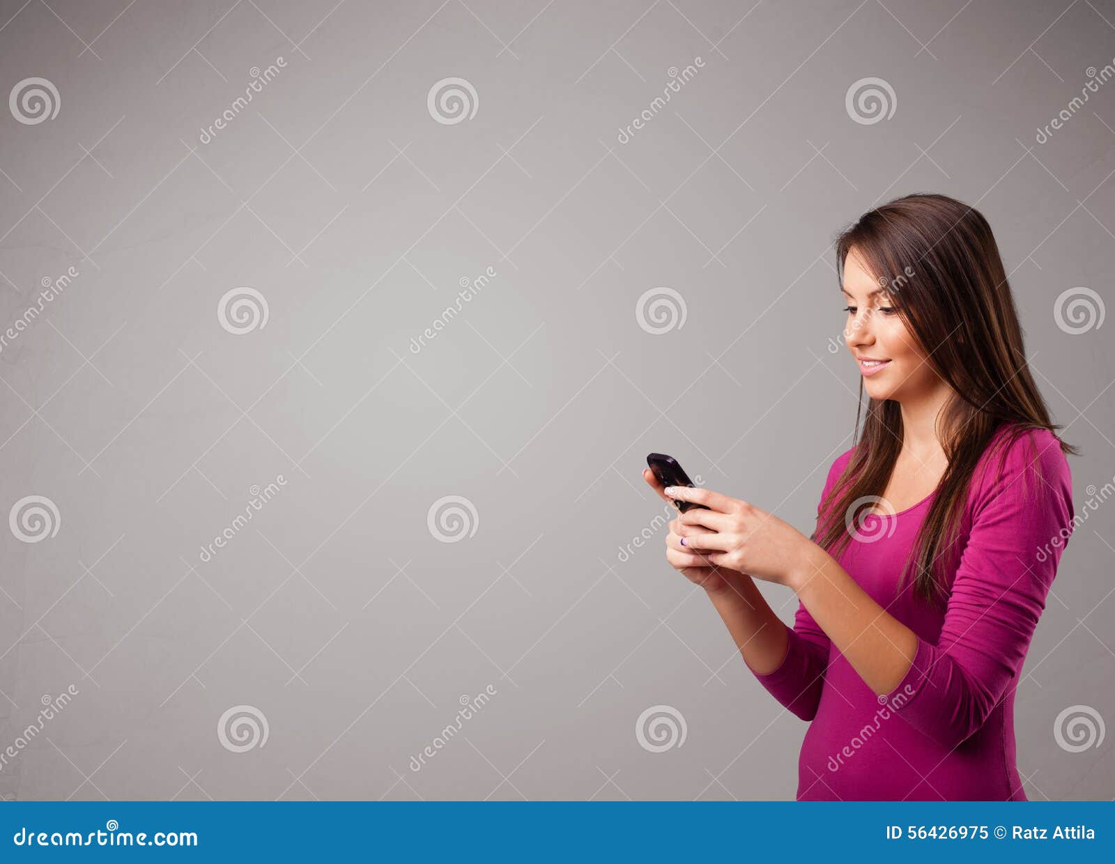 Young Lady Standing and Holding a Phone with Copy Space Stock Image ...