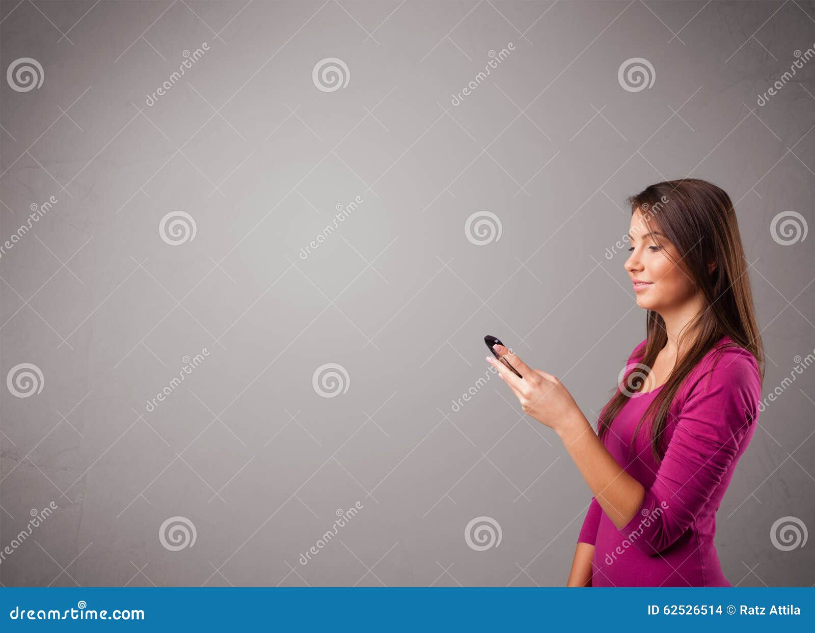 Young Lady Standing and Holding a Phone with Copy Space Stock Photo ...