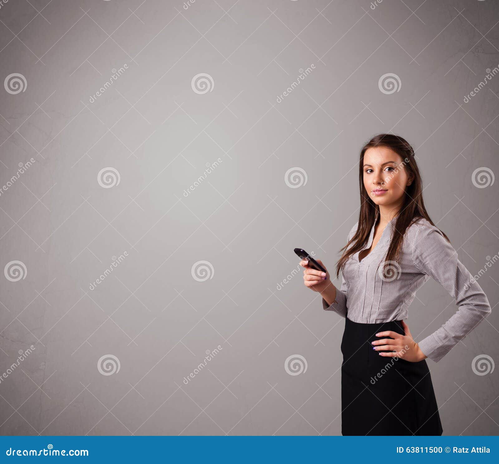 Young Lady Standing and Holding a Phone with Copy Space Stock Photo ...