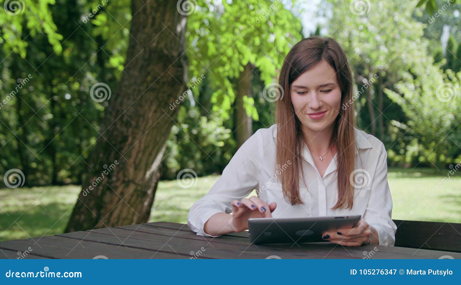 Young Lady Using an IPad in the Park Stock Image - Image of online ...