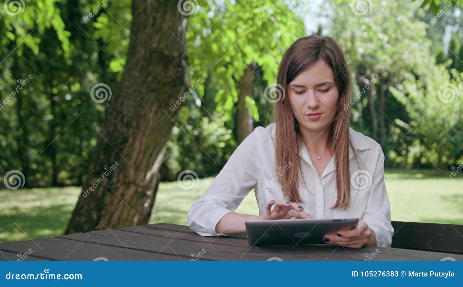 Young Lady Using an IPad in the Park Stock Image - Image of outdoors ...