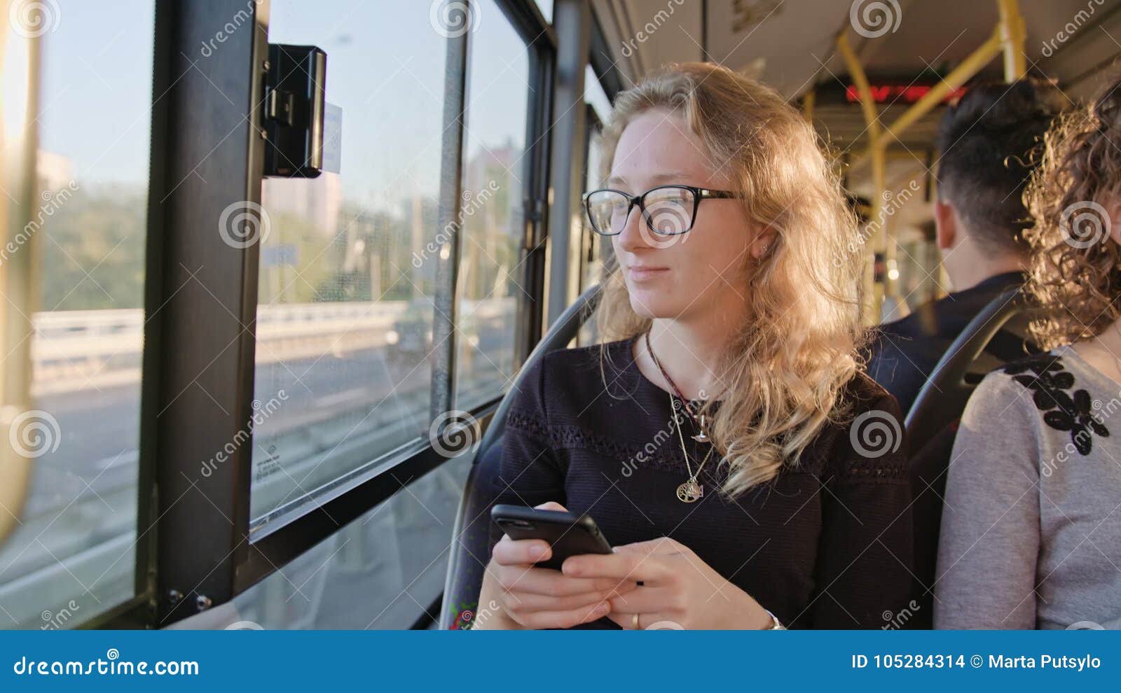 A Young Lady Using a Smartphone on the Bus Stock Photo - Image of ...