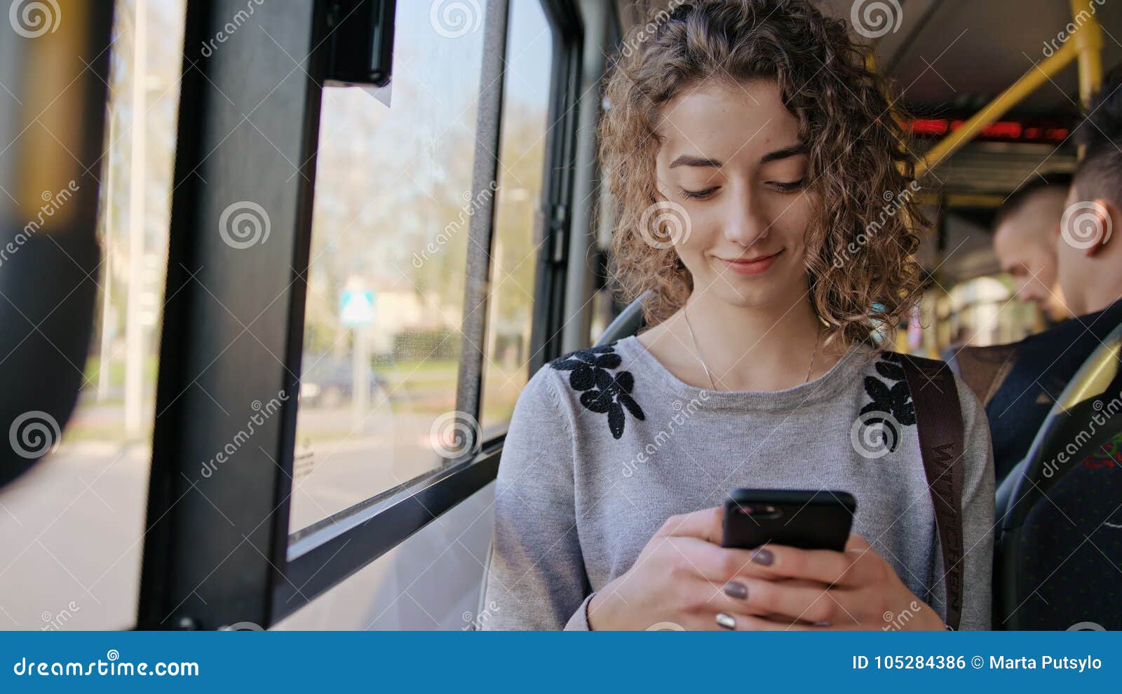 A Young Lady Using a Smartphone on the Bus Stock Photo - Image of ...