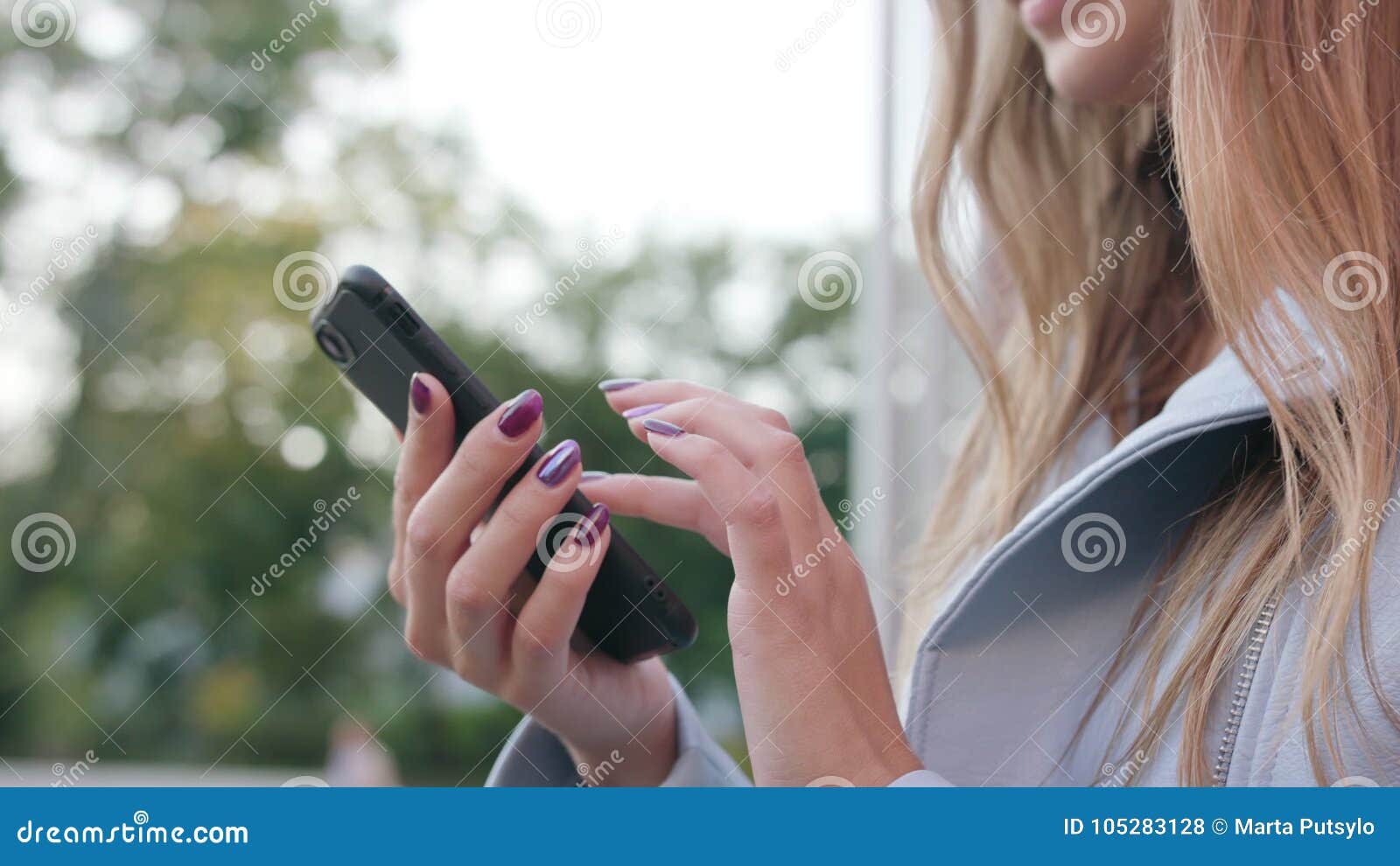 A Young Lady Using a Smartphone Outdoors Stock Photo - Image of hair ...