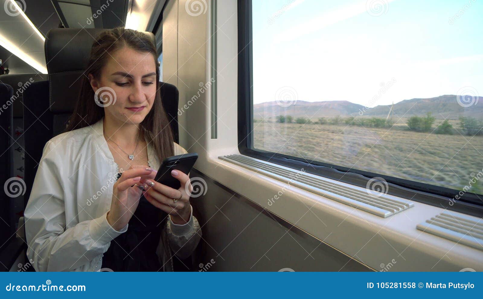 A Young Lady Using a Smartphone in the Train. Stock Photo - Image of ...