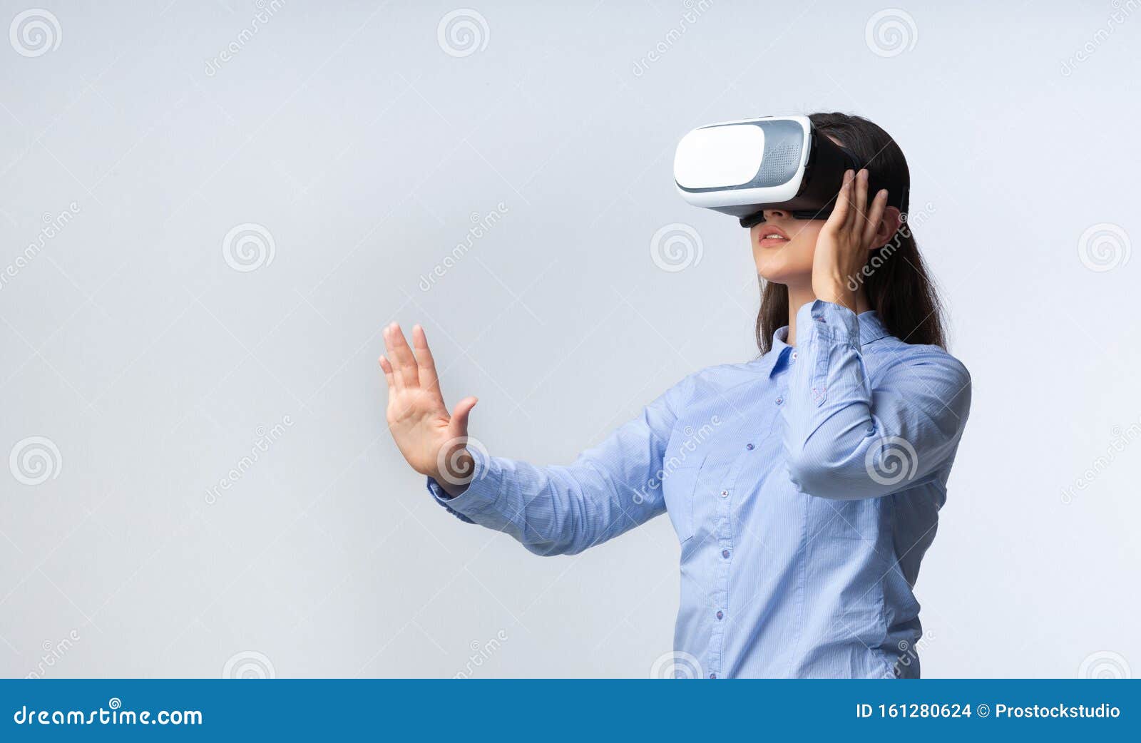 Young Lady Using VR Headset Standing Over Gray Background Stock Photo ...