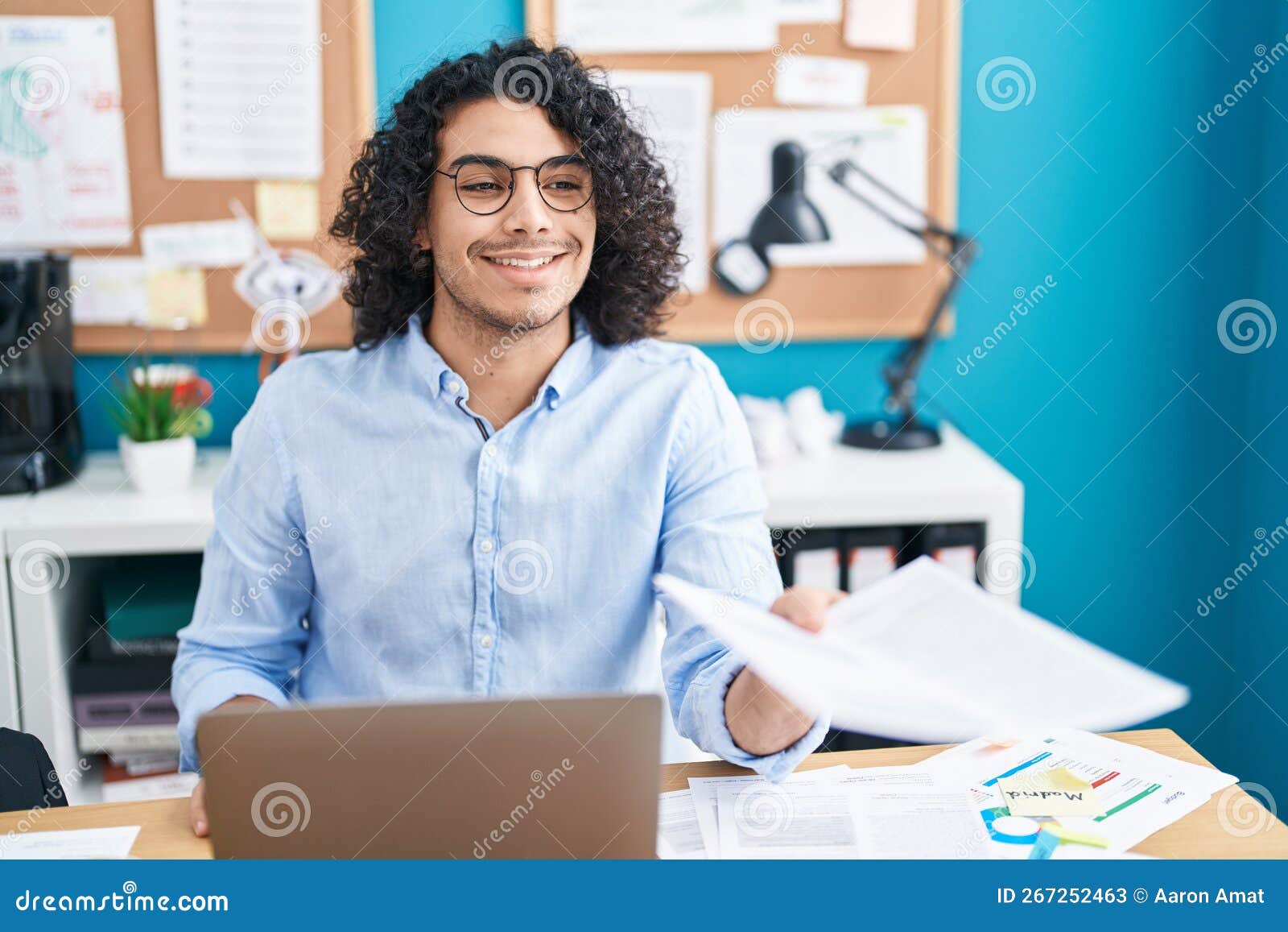 Young Latin Man Business Worker Using Laptop Holding Documents at ...