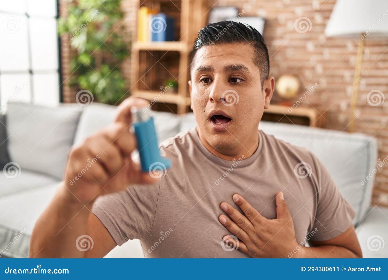 Young Latin Man Using Inhaler Sitting on Sofa at Home Stock Image ...