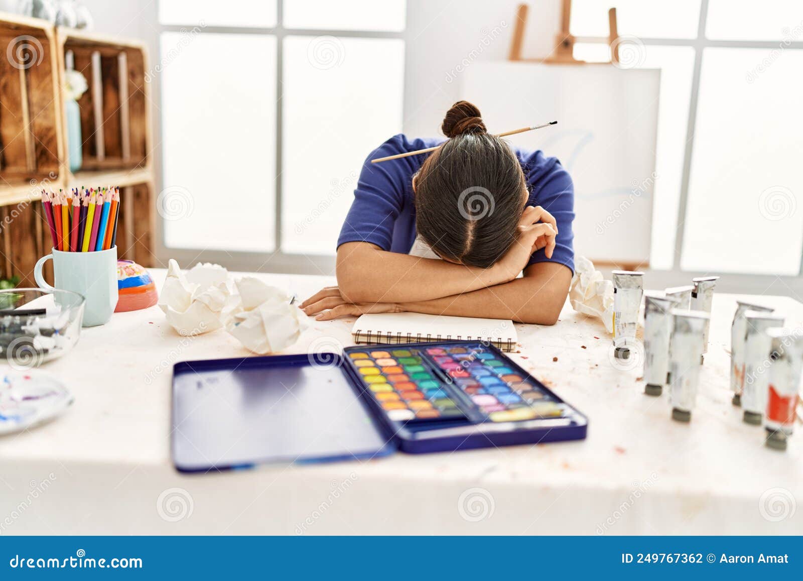 Young Latin Woman Crying Sitting on Table at Art Studio Stock Photo ...