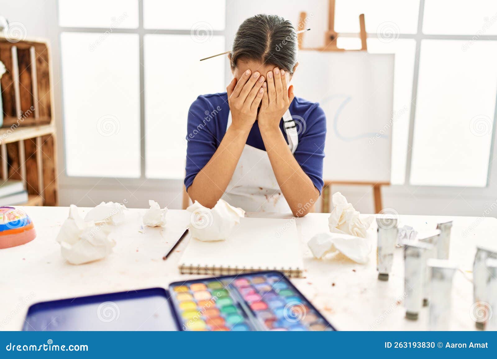 Young Latin Woman Crying Sitting on Table at Art Studio Stock Photo ...