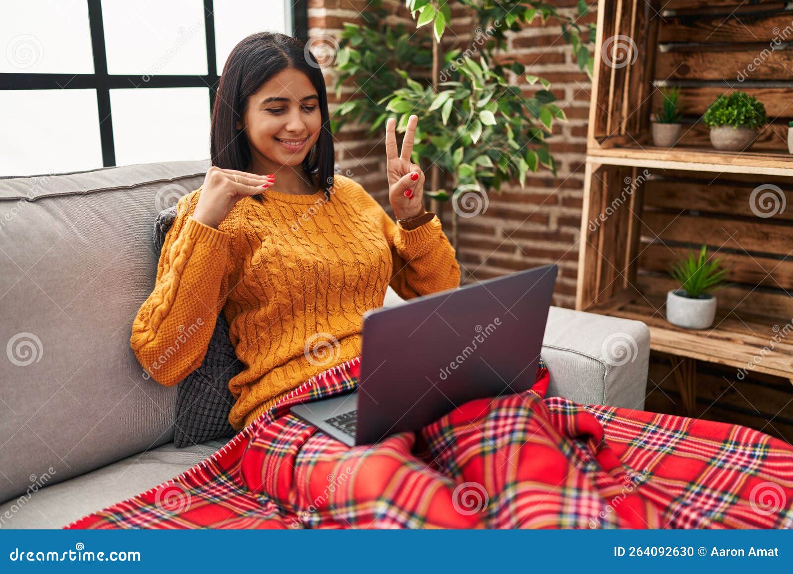 Young Latin Woman Having Video Call Using Deaf Sign Language at Home ...