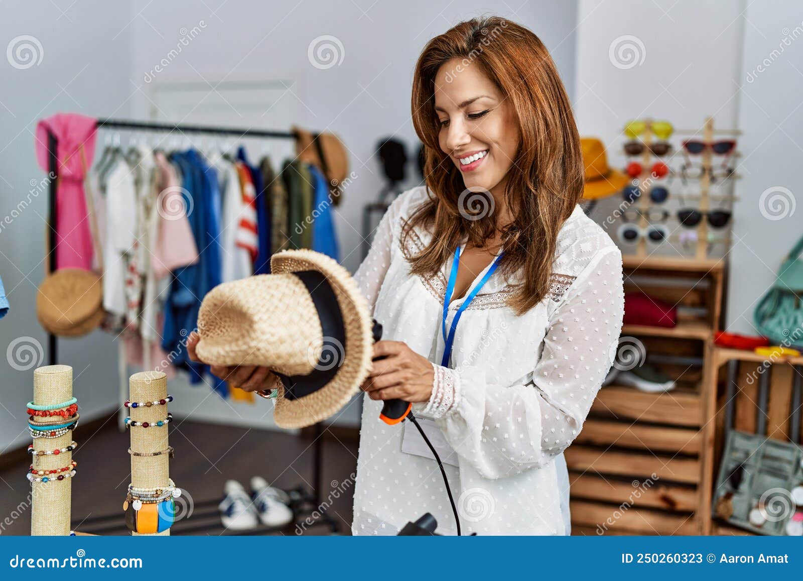 Young Latin Woman Shopkeeper Scanning Hat Using Barcode Reader at ...