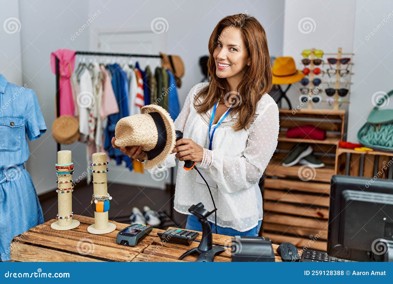 Young Latin Woman Shopkeeper Scanning Hat Using Barcode Reader at ...