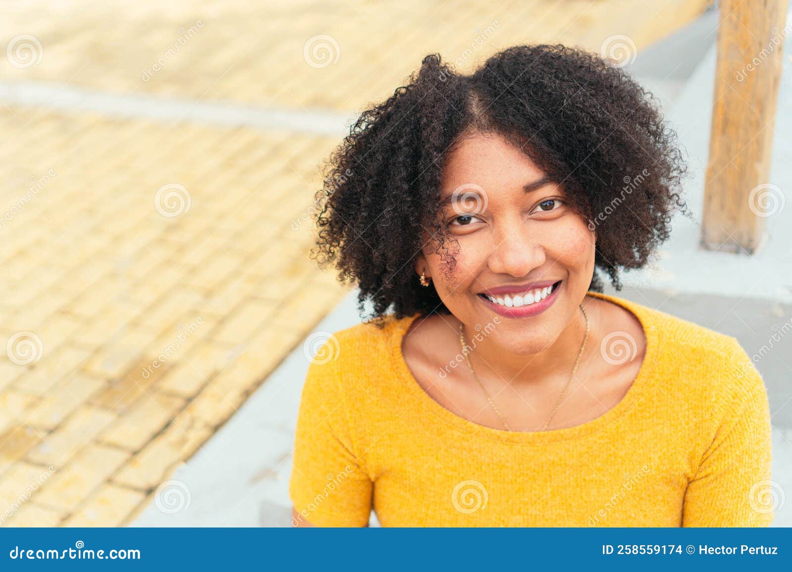 Young Latina Female with Afro Looking at Camera Stock Photo - Image of ...