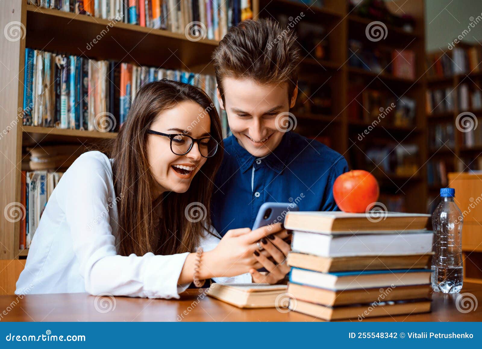 Young Laughing Couple Having Fun by Learning in the Library after ...