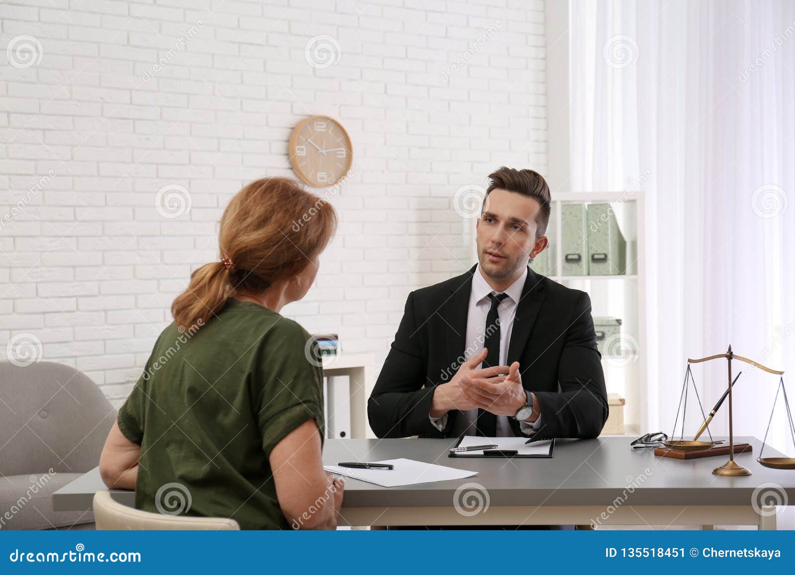 Lawyer Having Meeting And Consoling Solution To His Clients Provide ...