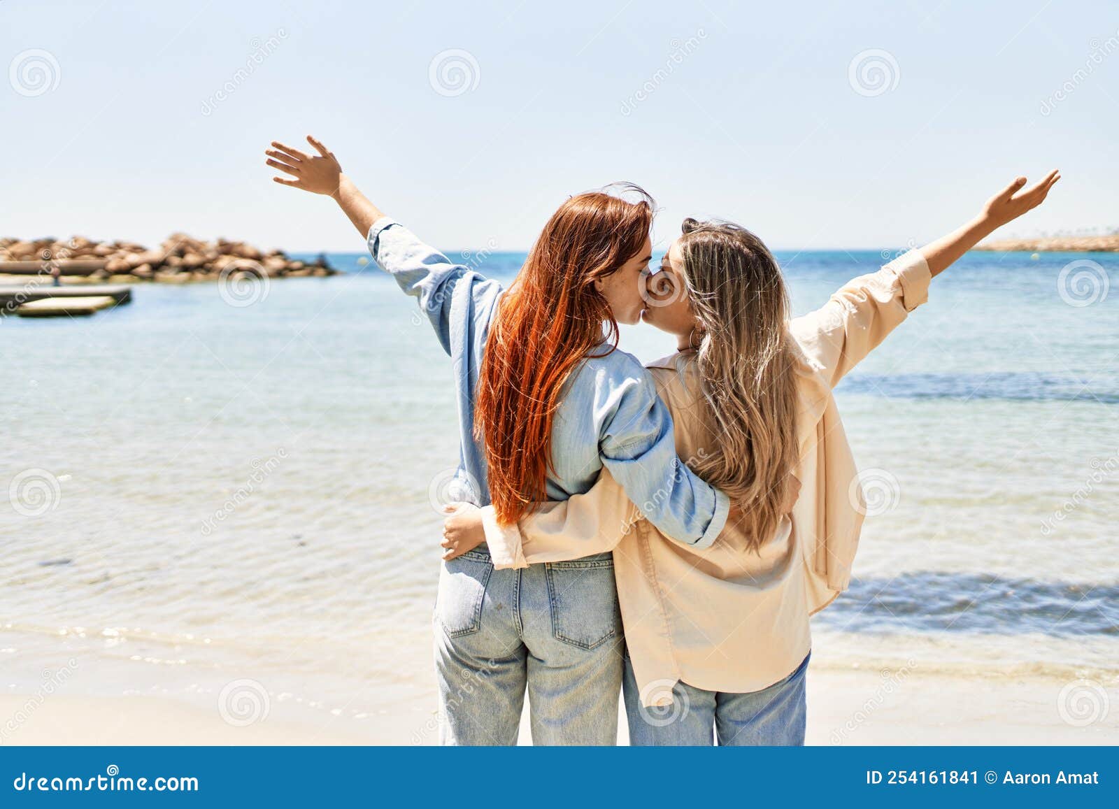 Young Lesbian Couple Of Two Women In Love At The Beach Stock Image