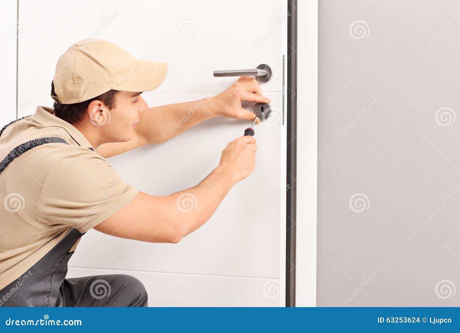 Young Locksmith Installing a Lock on a Door Stock Photo - Image of door ...