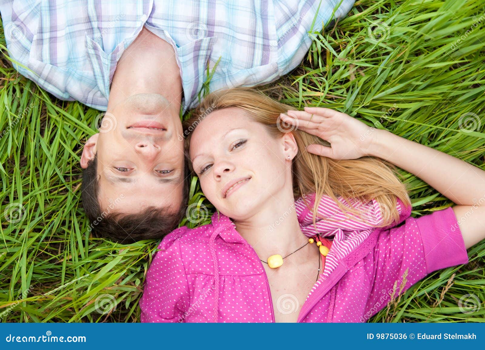 Young Love Couple Lay on Green Grass Stock Photo - Image of happy ...