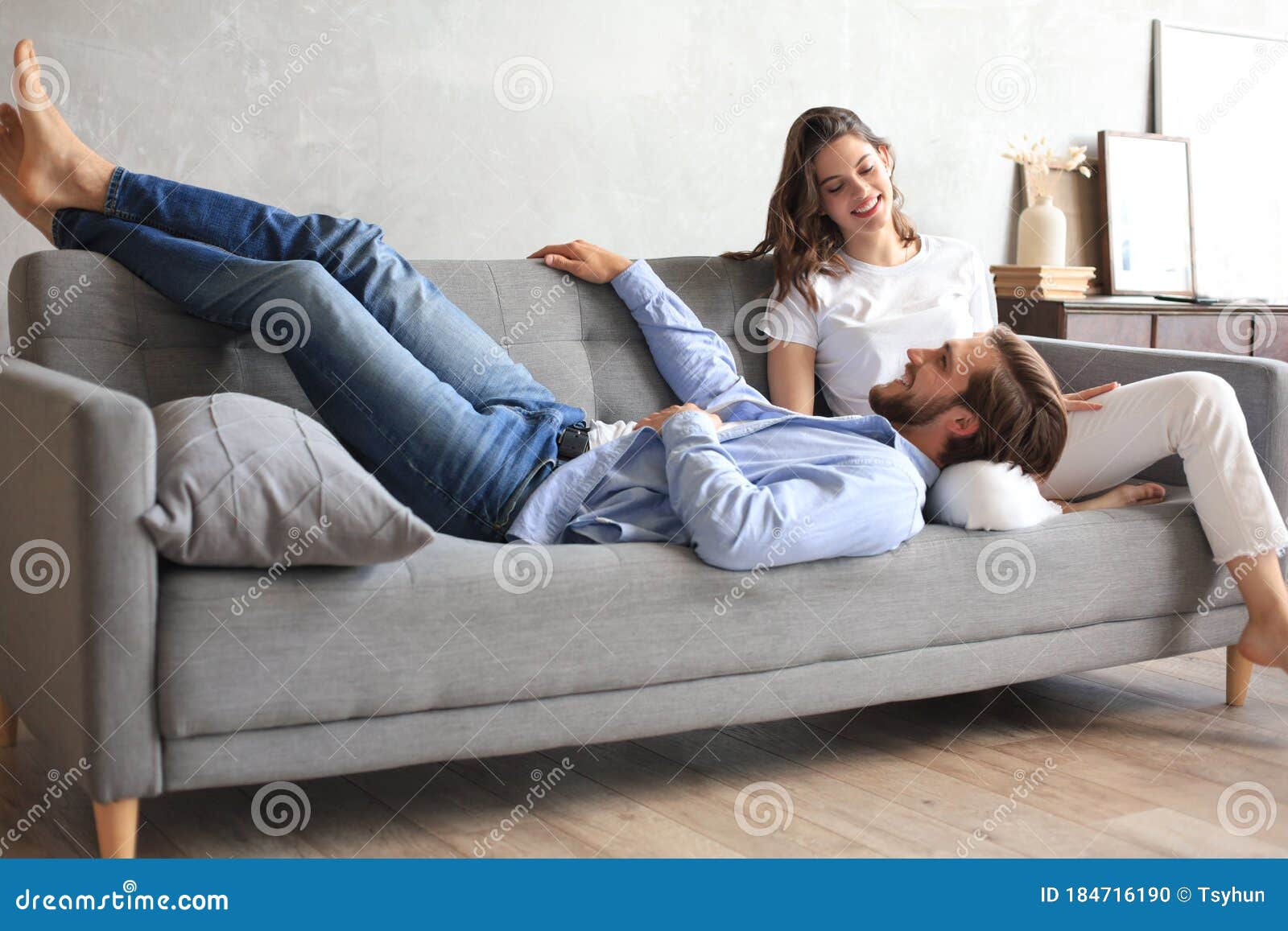 Young Loving Couple Relaxing On Sofa Together Husband Lying On Wife
