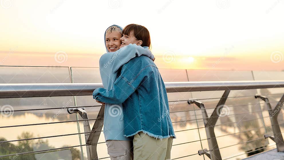 Young Loving Lesbian Couple Cuddling And Looking Happy Two Women