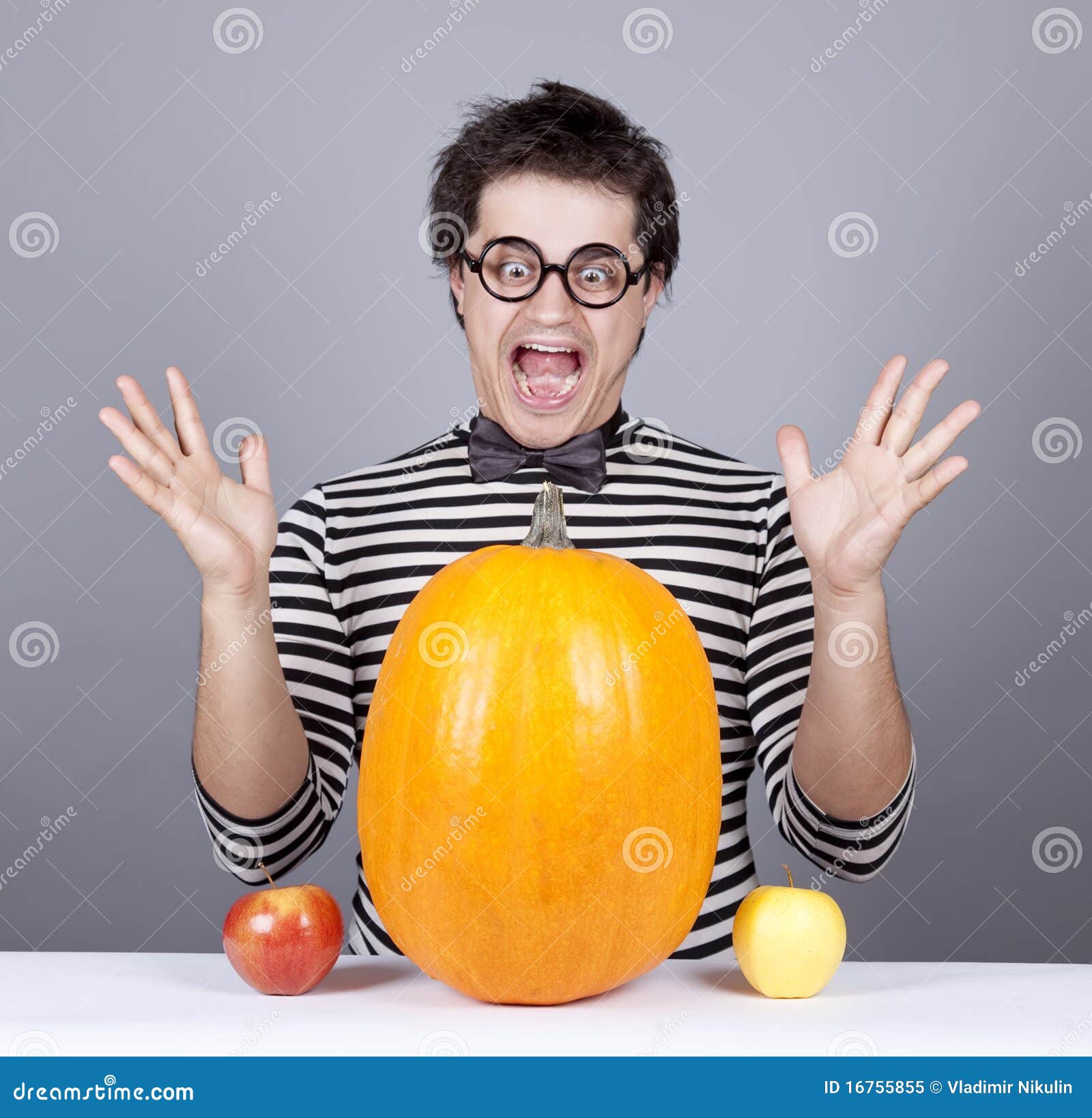 The Young Mad Men Try To Eat Apples and Pumpkin. Stock Image - Image of ...