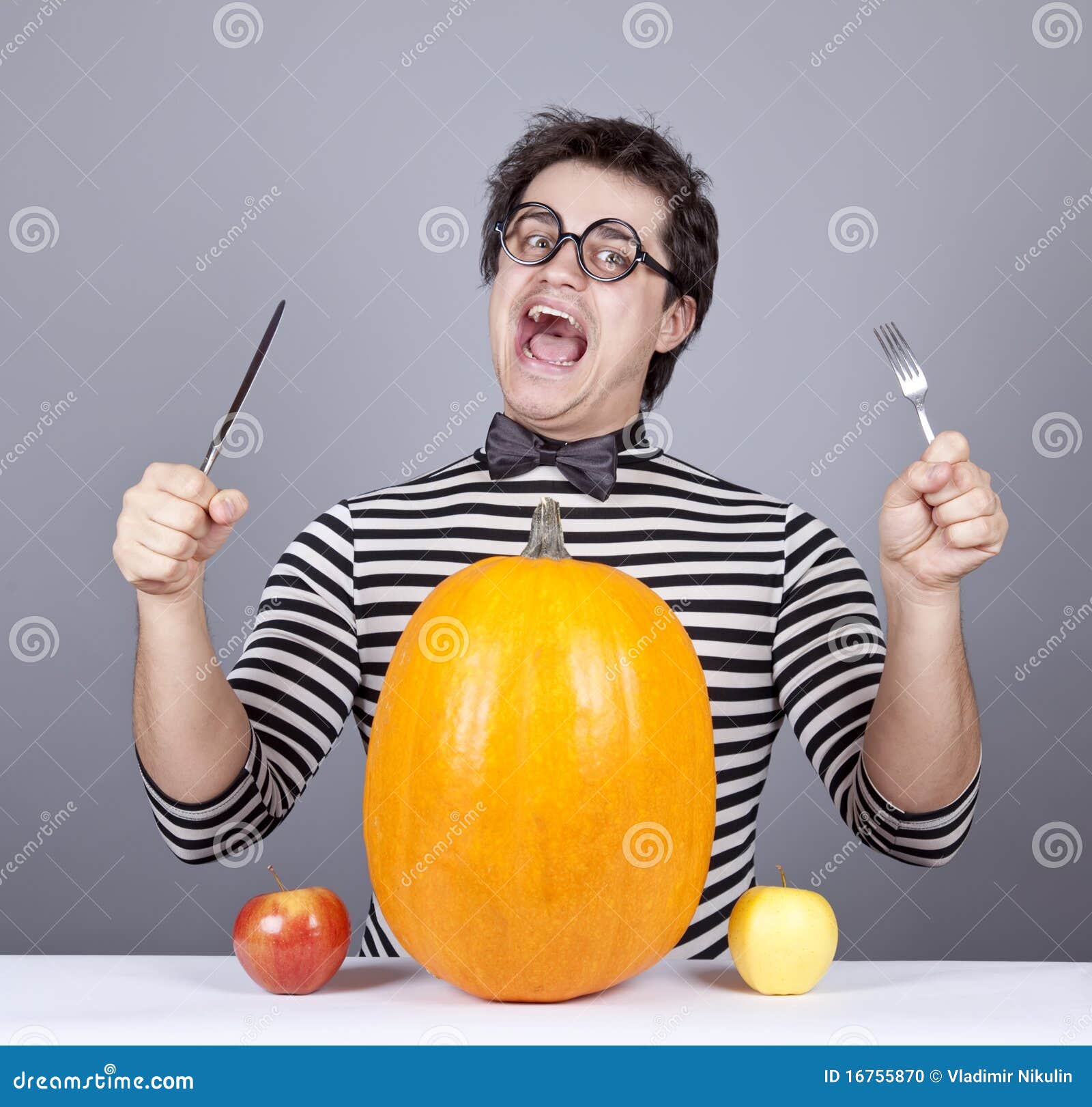 The Young Mad Men Try To Eat Apples and Pumpkin. Stock Photo - Image of ...