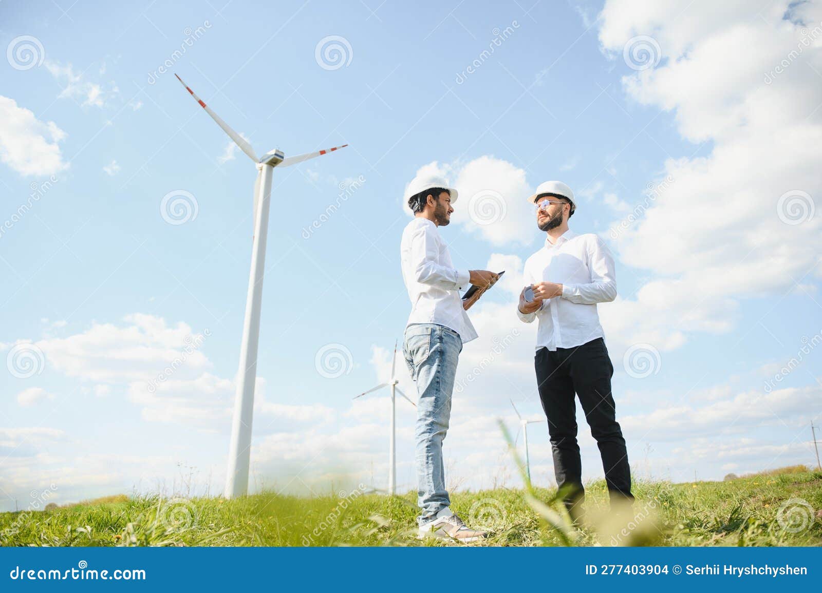 Young Maintenance Engineer Team Working in Wind Turbine Farm. Stock ...