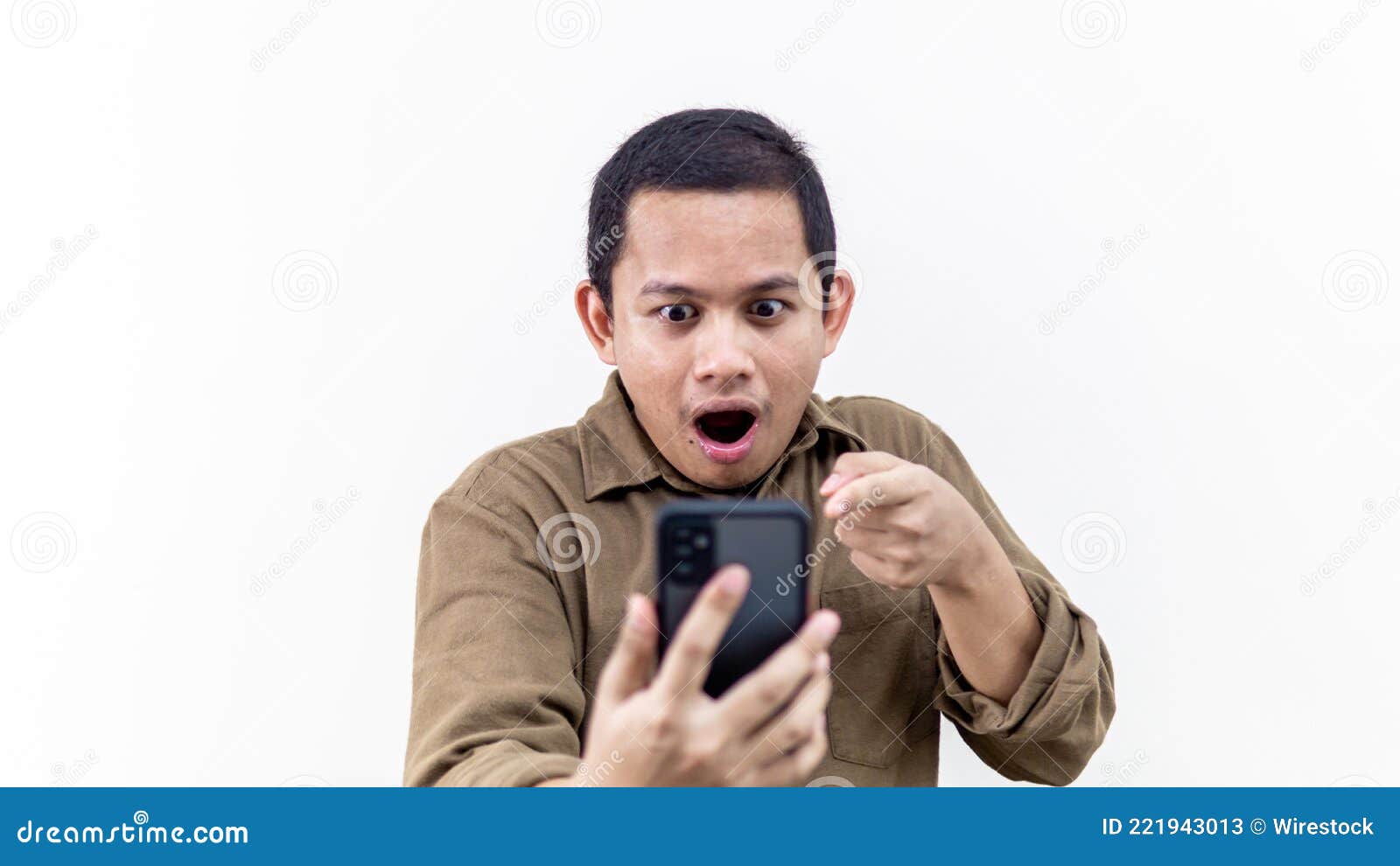 Young Malay Looking and Pointing at the Smartphone Screen with a ...