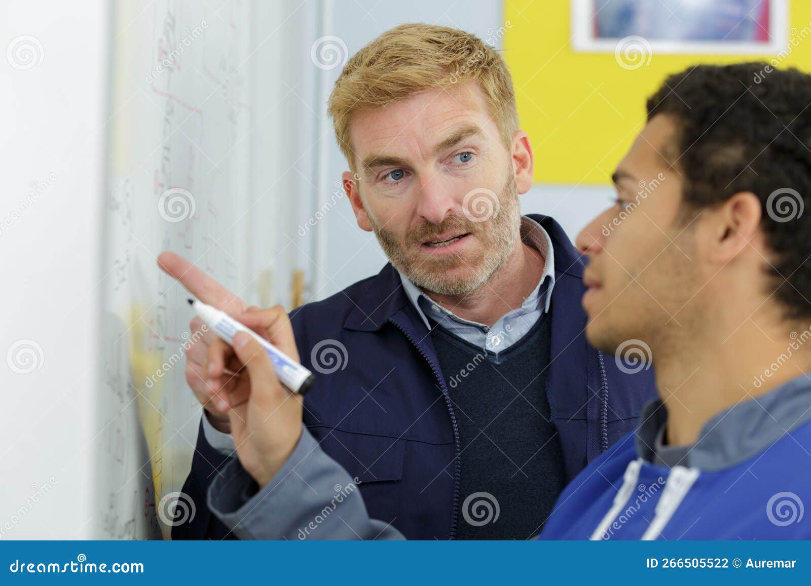 Young Male Apprentice Writing on Whiteboard Stock Photo - Image of ...