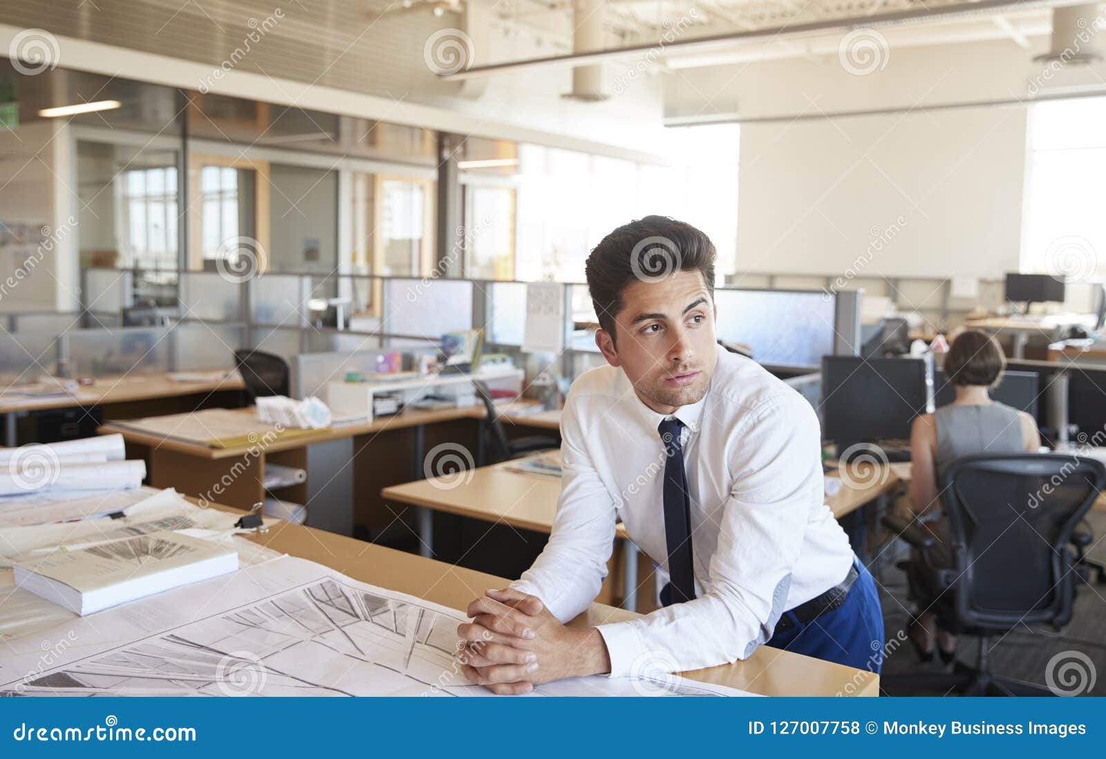 Young Male Architect Leaning on Desk in Open Plan Office Stock Photo ...