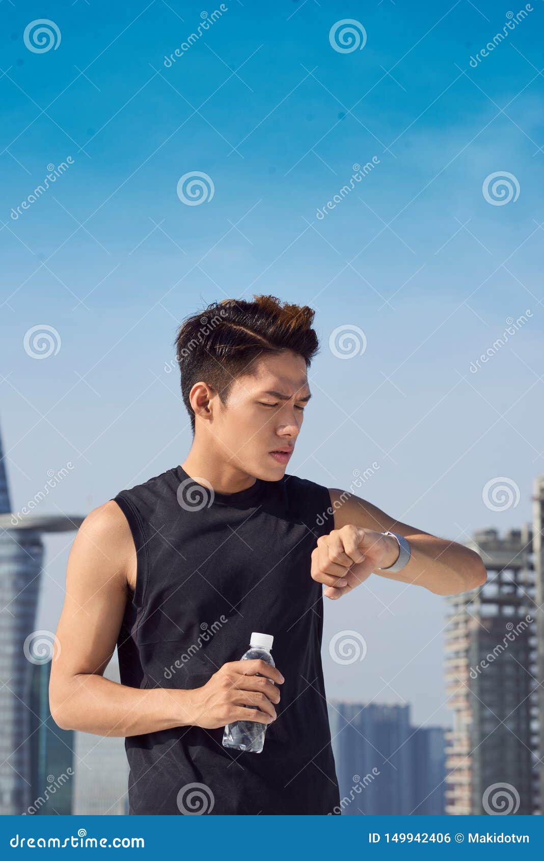 Young Male Athlete Checking Smartwatch, Over Shoulder View Stock Photo ...