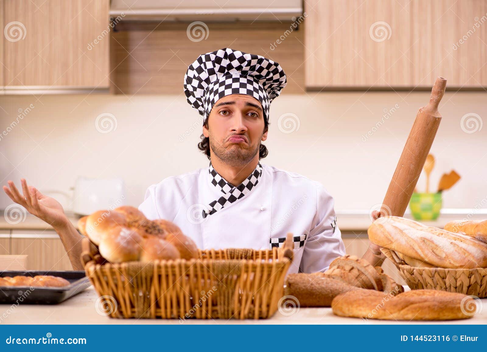 The Young Male Baker Working in Kitchen Stock Photo - Image of male ...