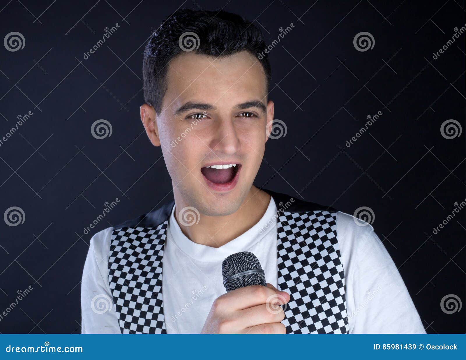 Young Male Black-haired Pop Singer Sings To Microphone Stock Image ...