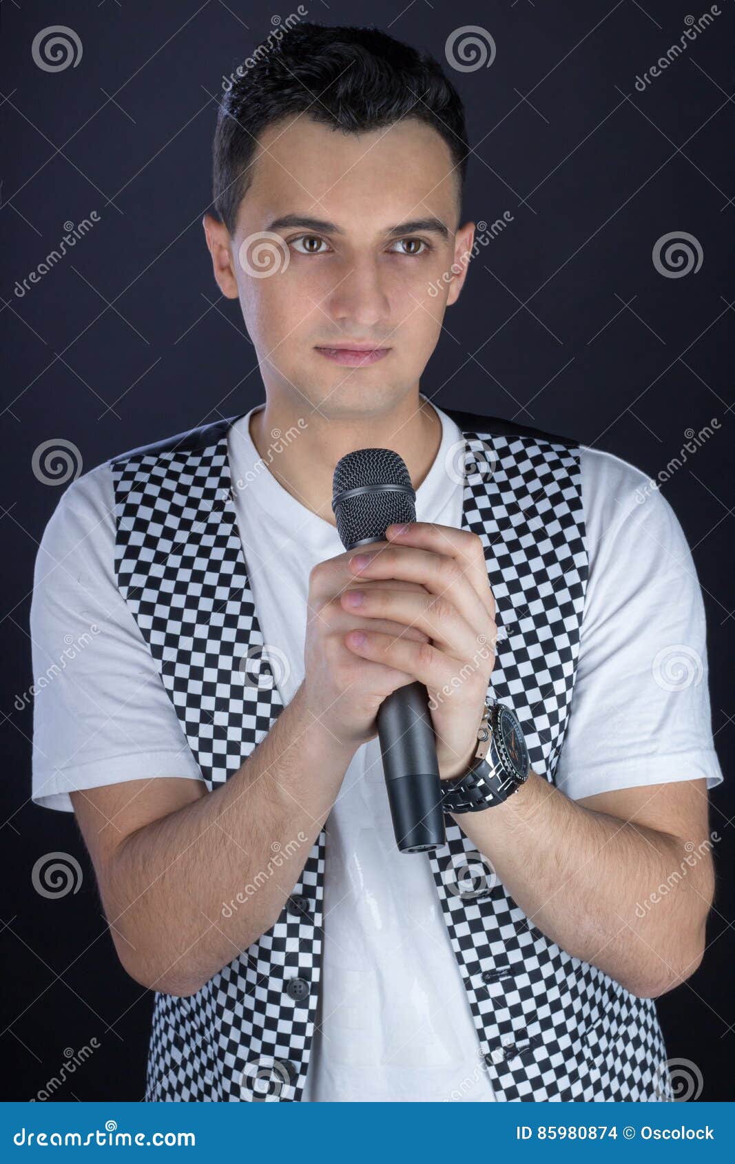 Young Male Black-haired Rock Singer Performs Singing To Microphone ...