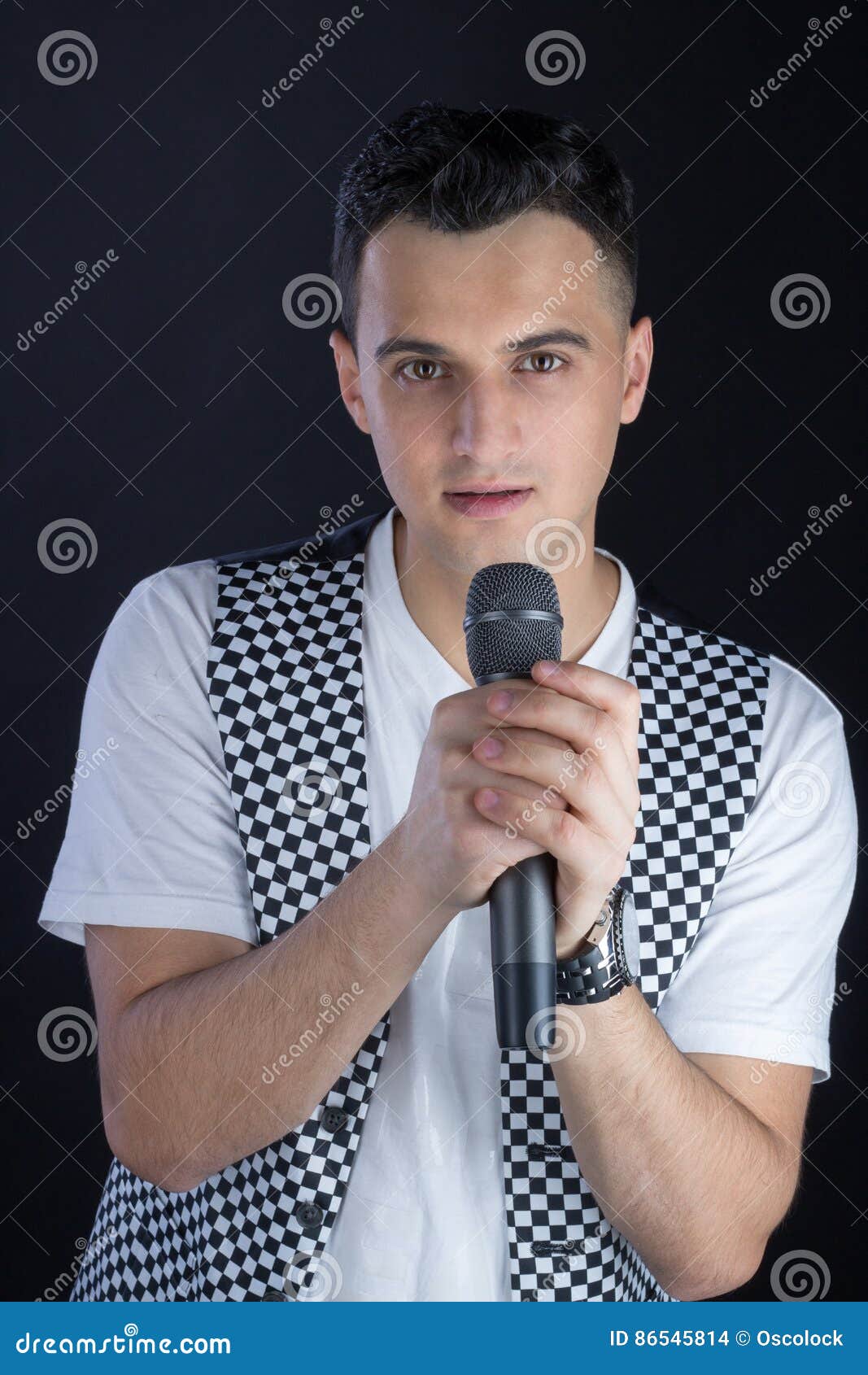 Young Male Black-haired Singer Performs Singing To Microphone Stock ...