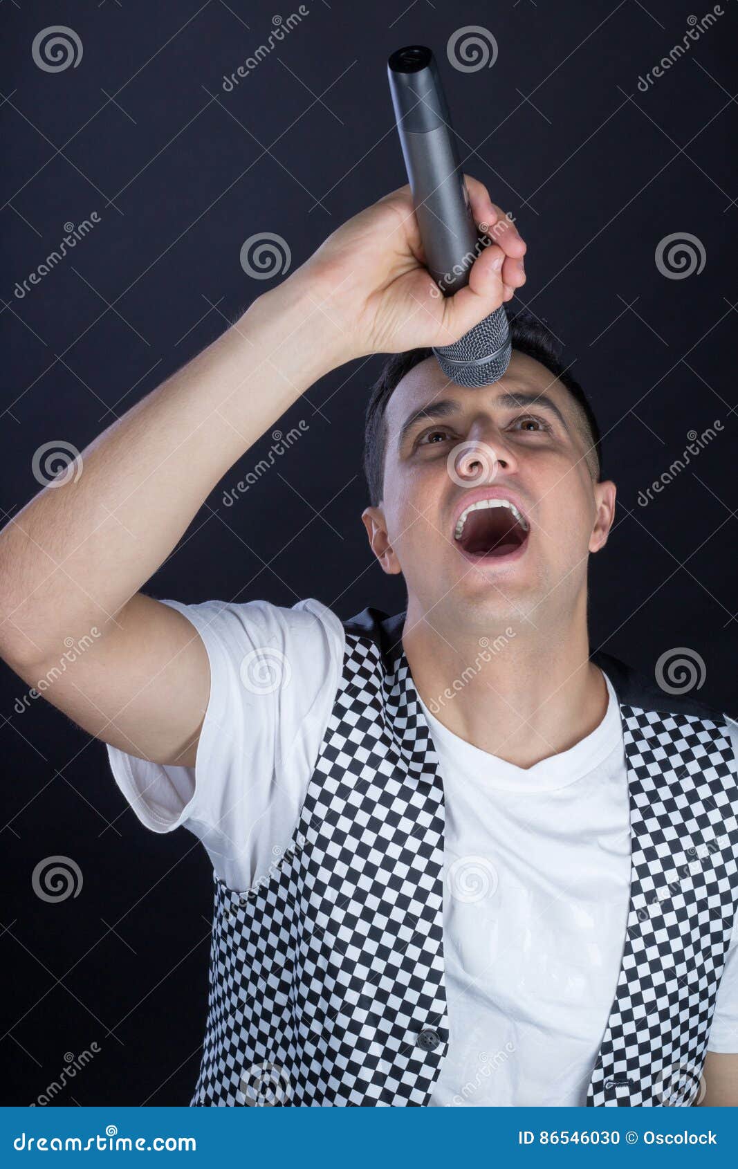 Young Male Black-haired Vocalist Performs Singing To Microphone Stock ...