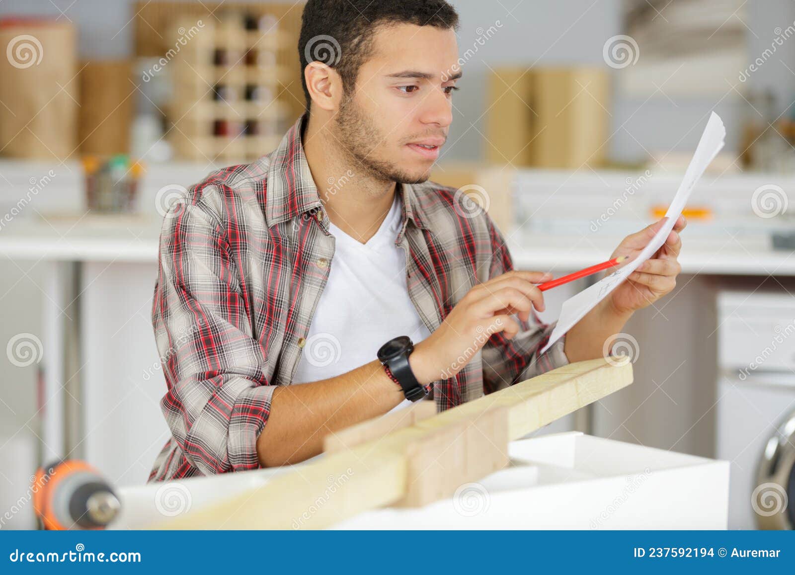 A Man Reading Instructions For DIY Assembly Of A Computer Or Office ...