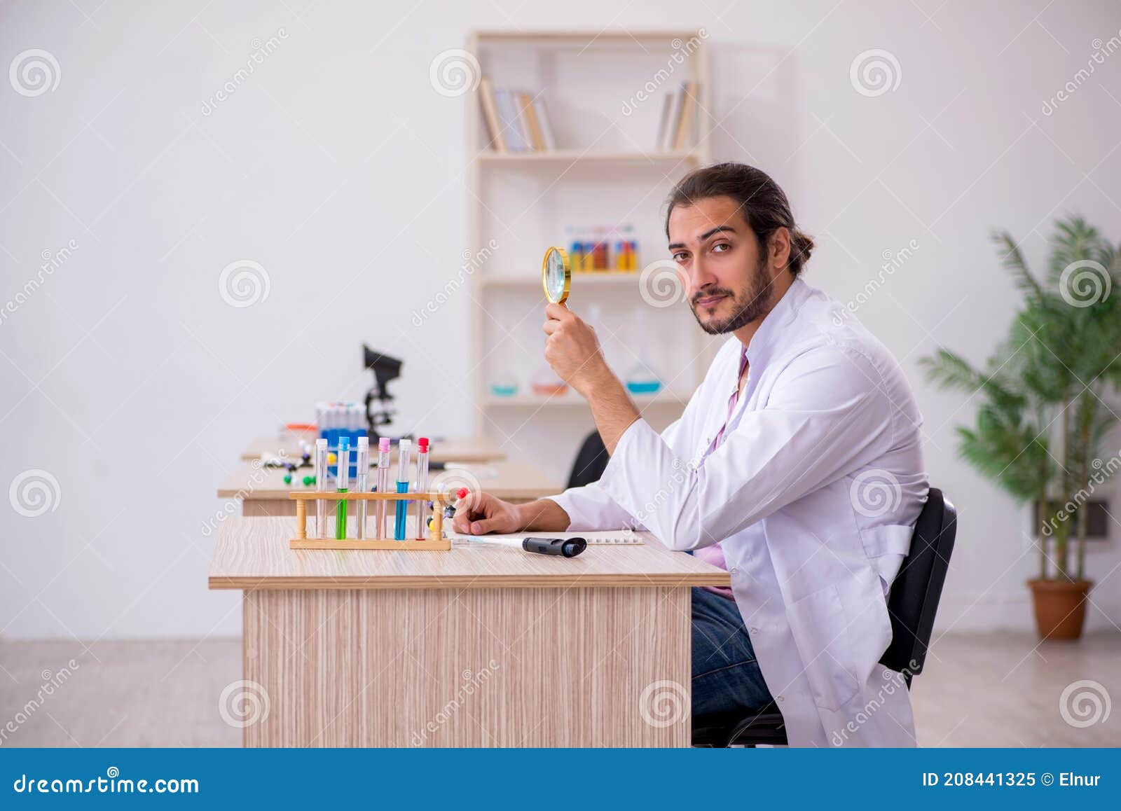 Young Male Chemist Sitting at the Desk in the Classroom Stock Image ...