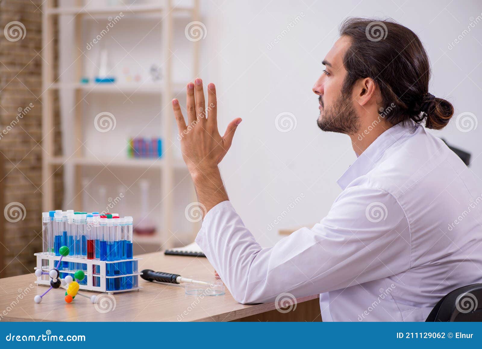 Young Male Chemist Sitting at the Desk in the Classroom Stock Photo ...