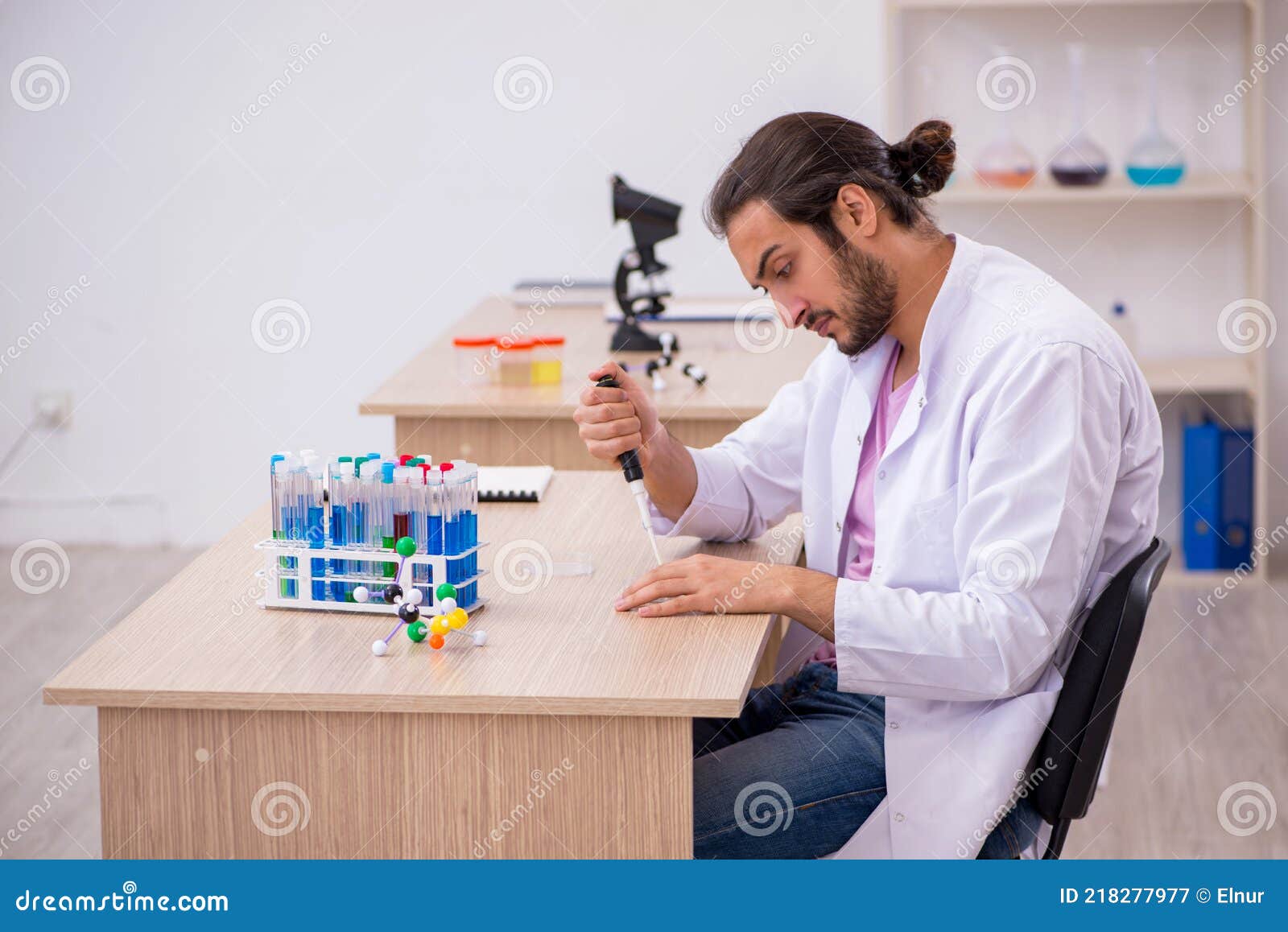 Young Male Chemist Sitting at the Desk in the Classroom Stock Image ...