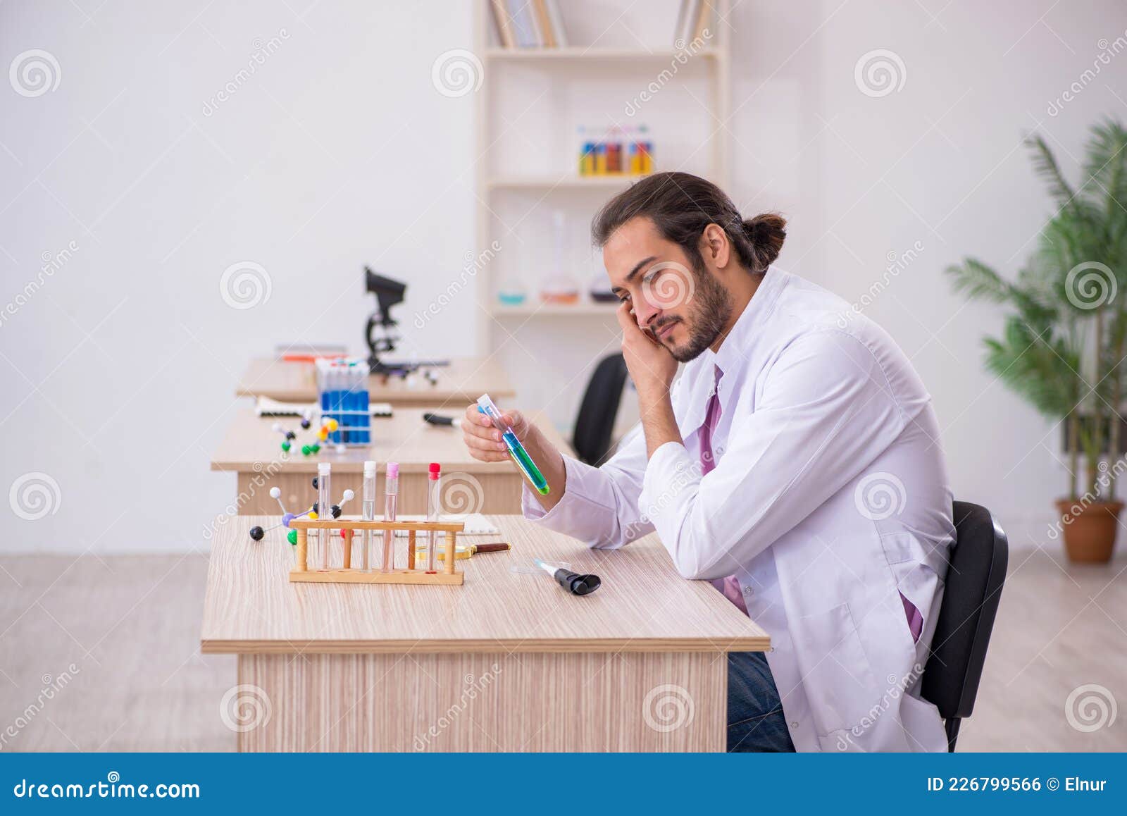 Young Male Chemist Sitting at the Desk in the Classroom Stock Photo ...